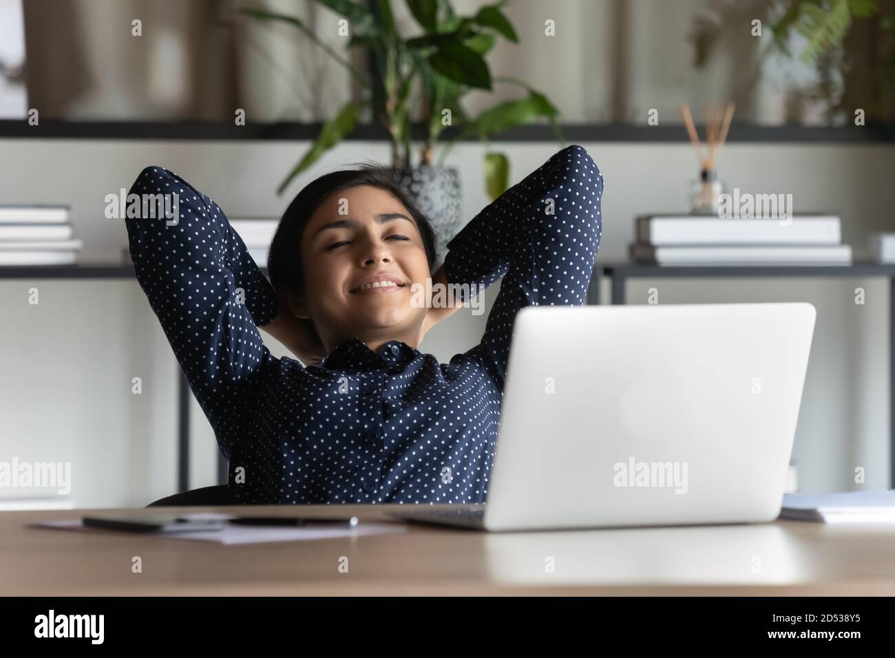 Happy indian female employee relax at workplace Stock Photo - Alamy