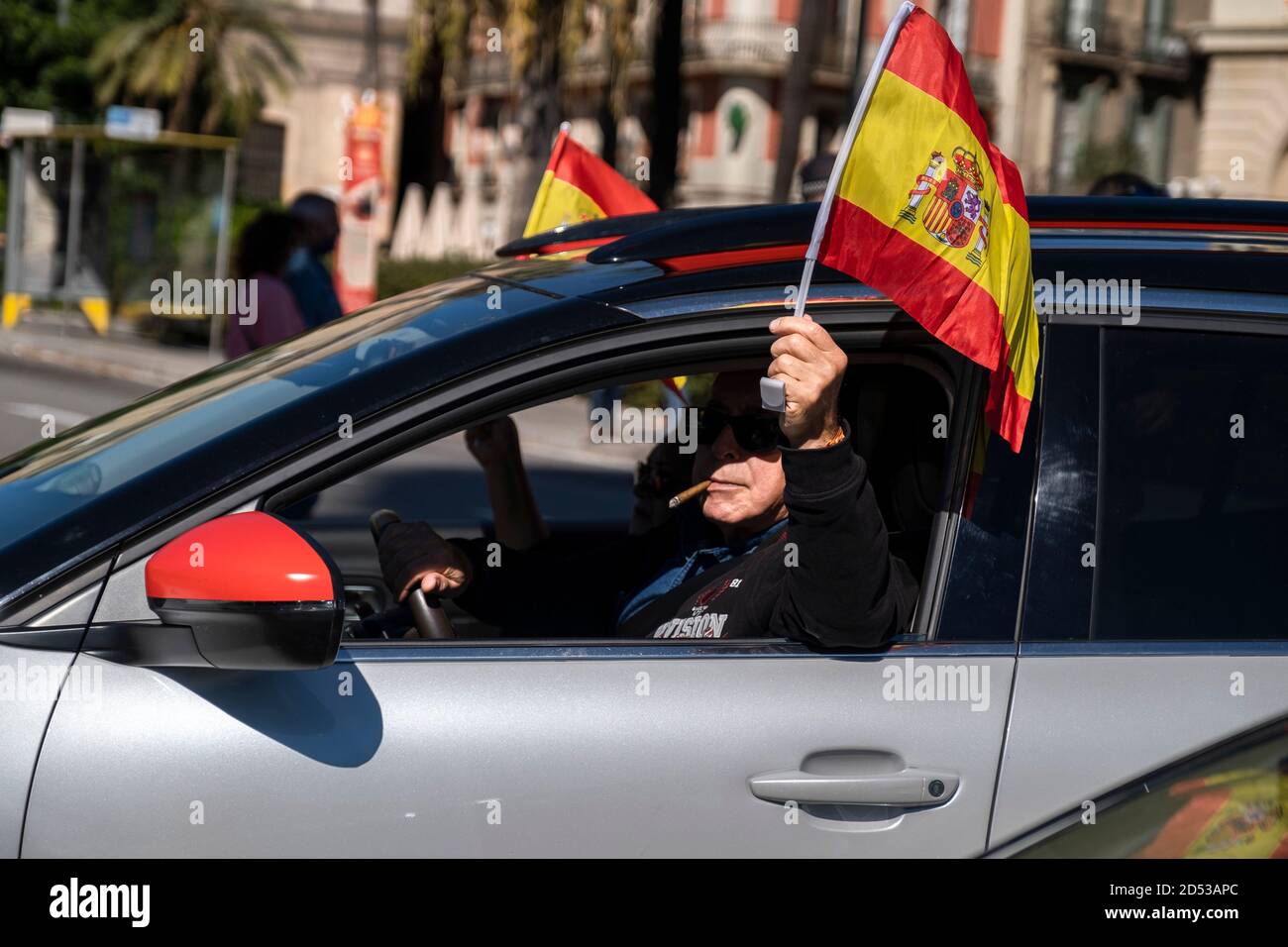 A protester in a car seen smoking cigarette while holding a Spanish ...