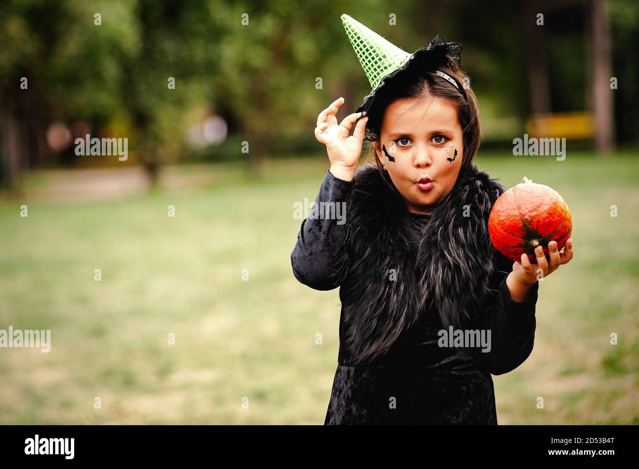 Girl with curly hair in a witch costume for Halloween Stock Photo - Alamy