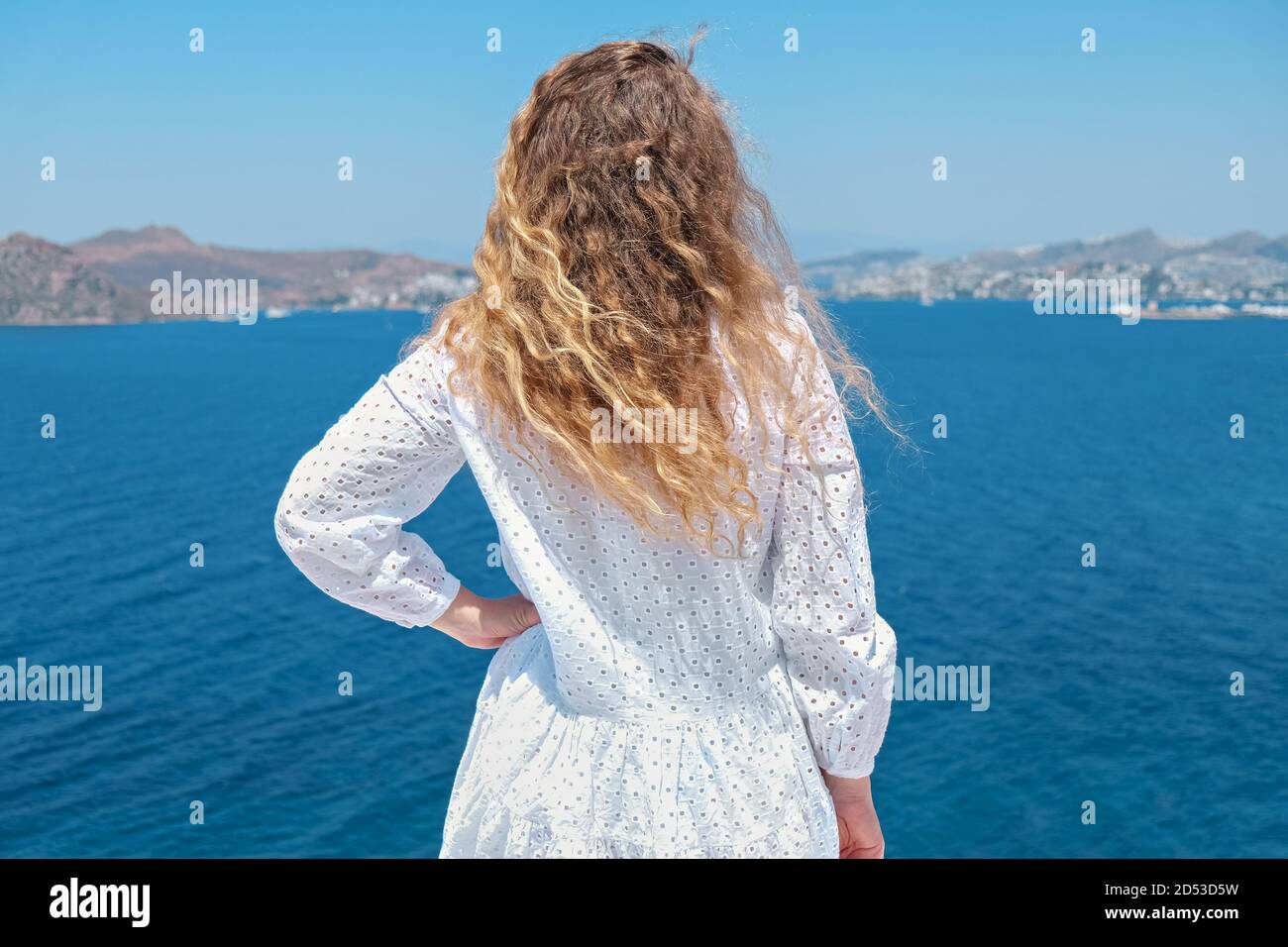 Beautiful woman from back in white dress sunglasses on white terrace of ...