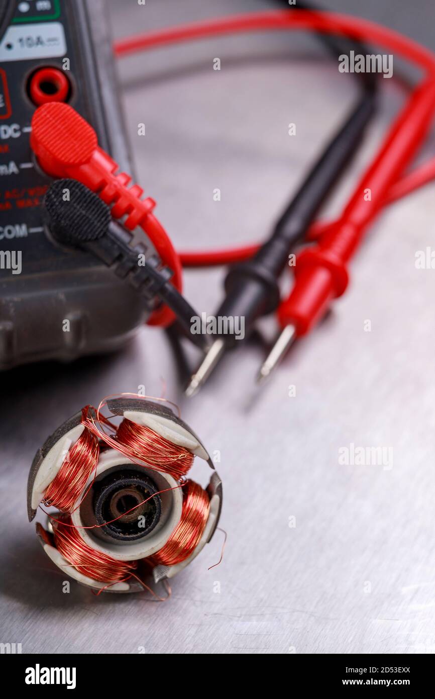 Damaged electric motor rotor and electric meter. Measurement work in an ...