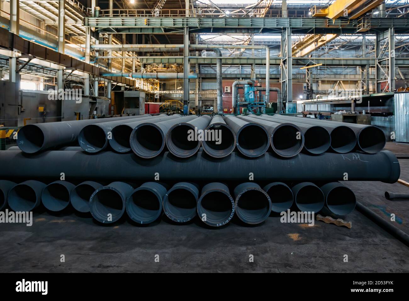 New cast iron pipes for pipeline construction in warehouse Stock Photo ...