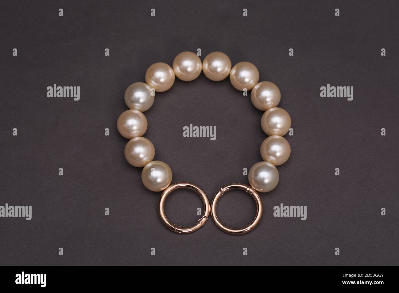 The handle of large pearls for the bag is on a gray background Stock ...
