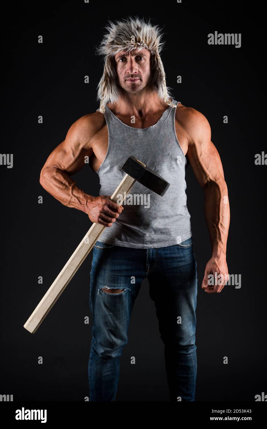 Manual worker. Worker hold hammer in strong arms. Athletic man black ...
