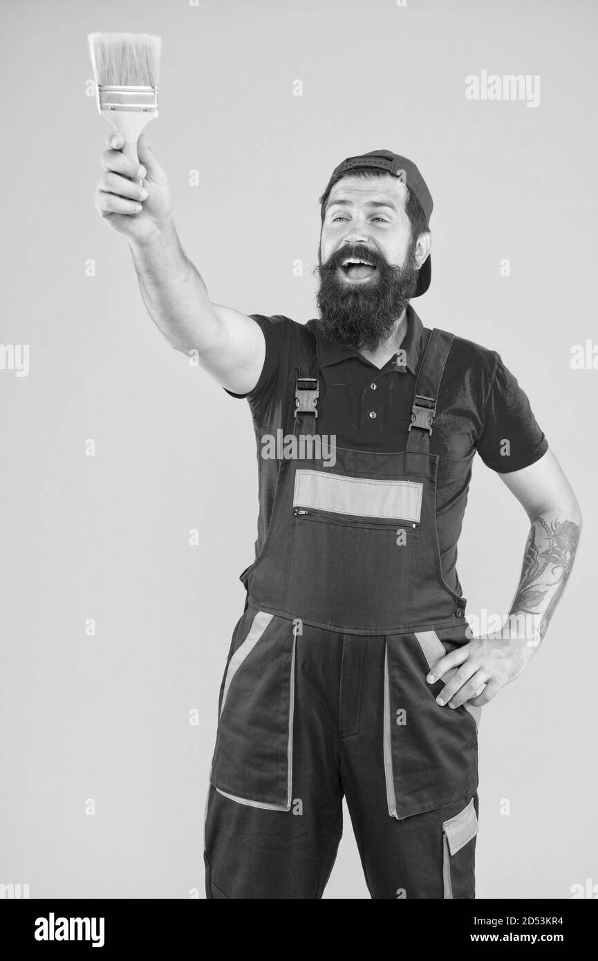 Construction and renovation. Bearded mature man painter. Primer and ...