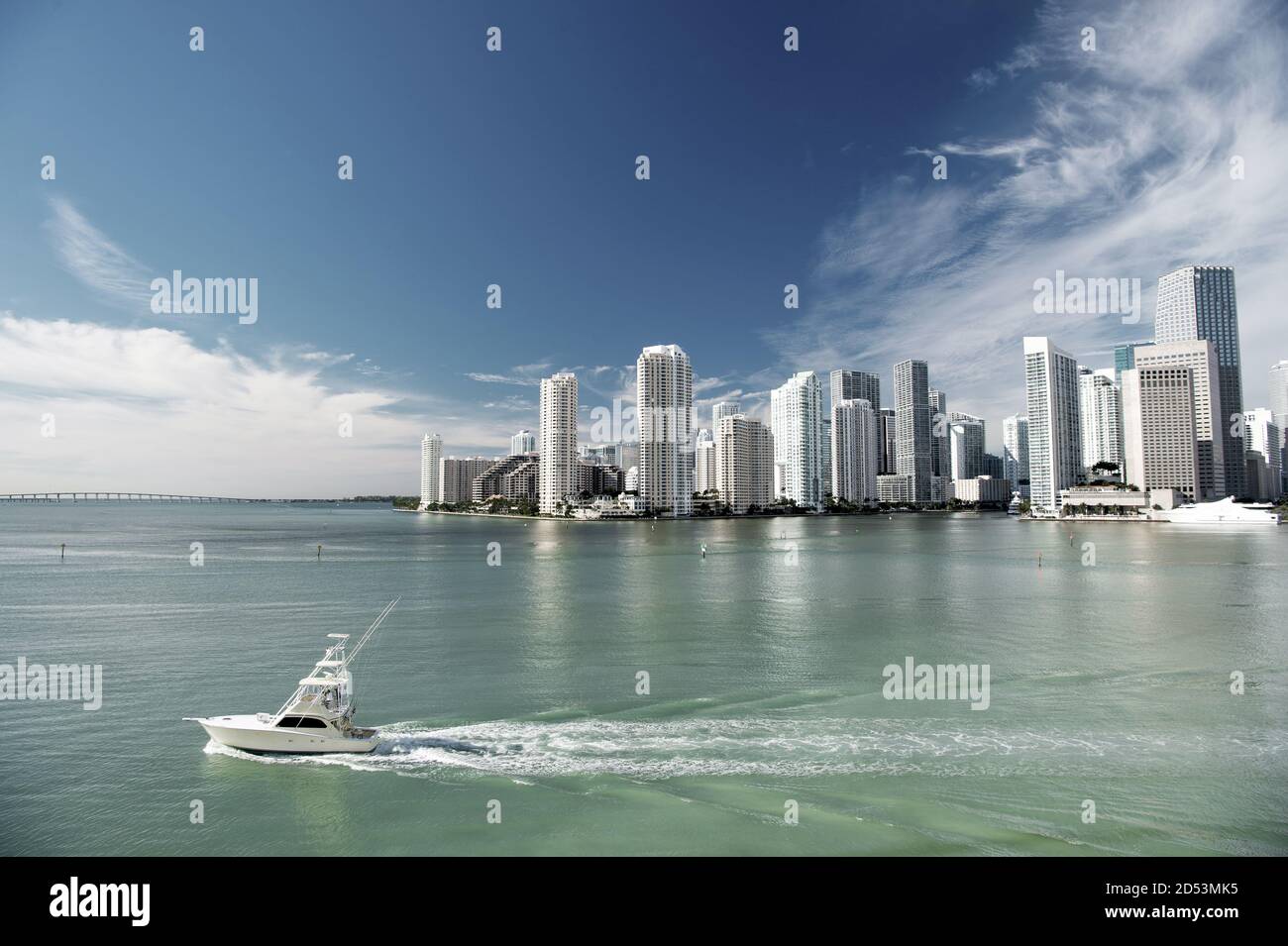 Aerial view of Miami skyscrapers with blue cloudy sky,white boat ...