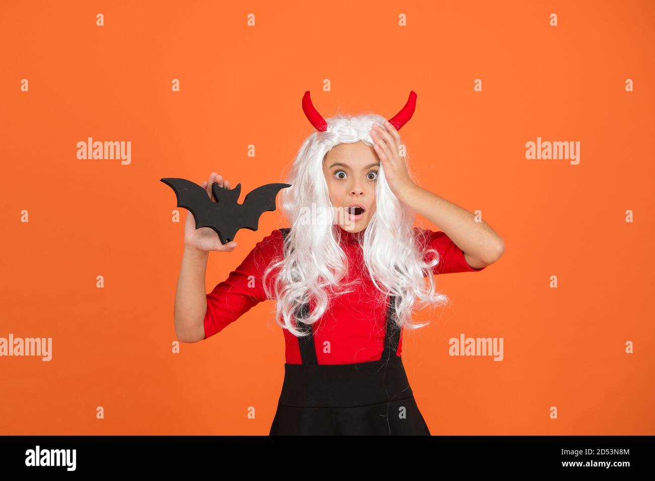 scared child in imp horn costume and white hair wig to halloween with ...