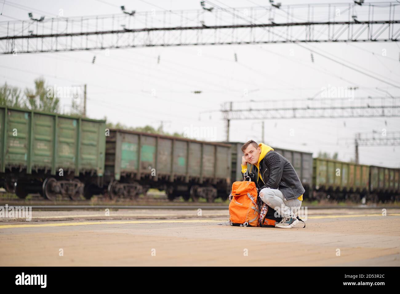 Man sitting on railway platform hi-res stock photography and images - Alamy