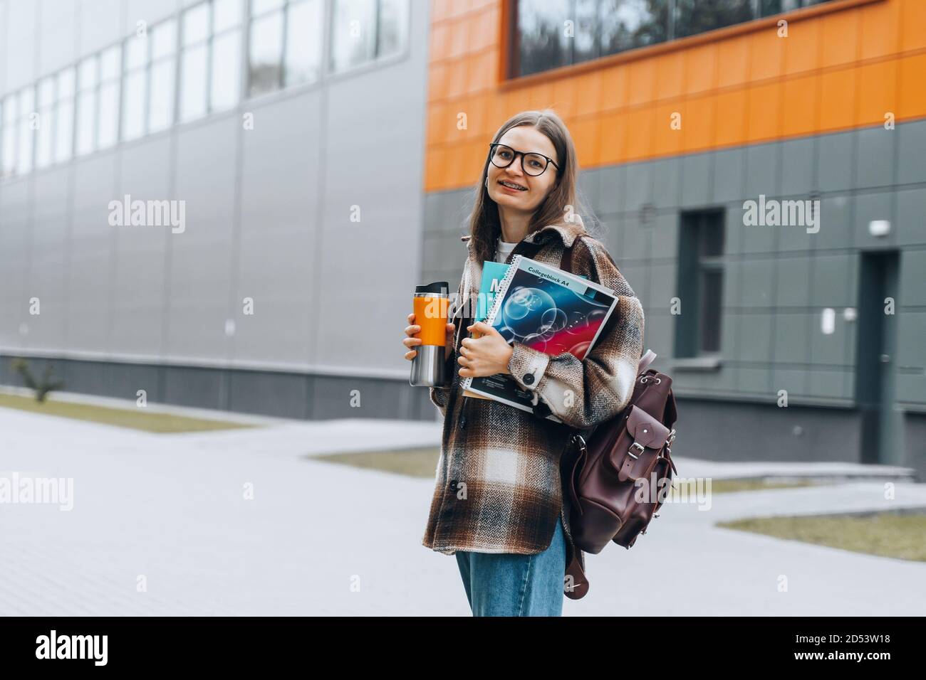 millennial caucasian female student in glasses and dental braces with ...