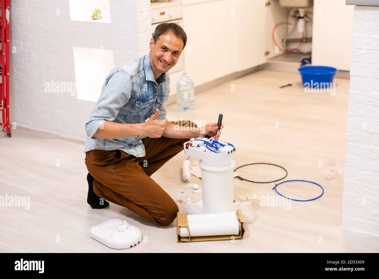 Plumber installs a water filter. water filter Stock Photo - Alamy