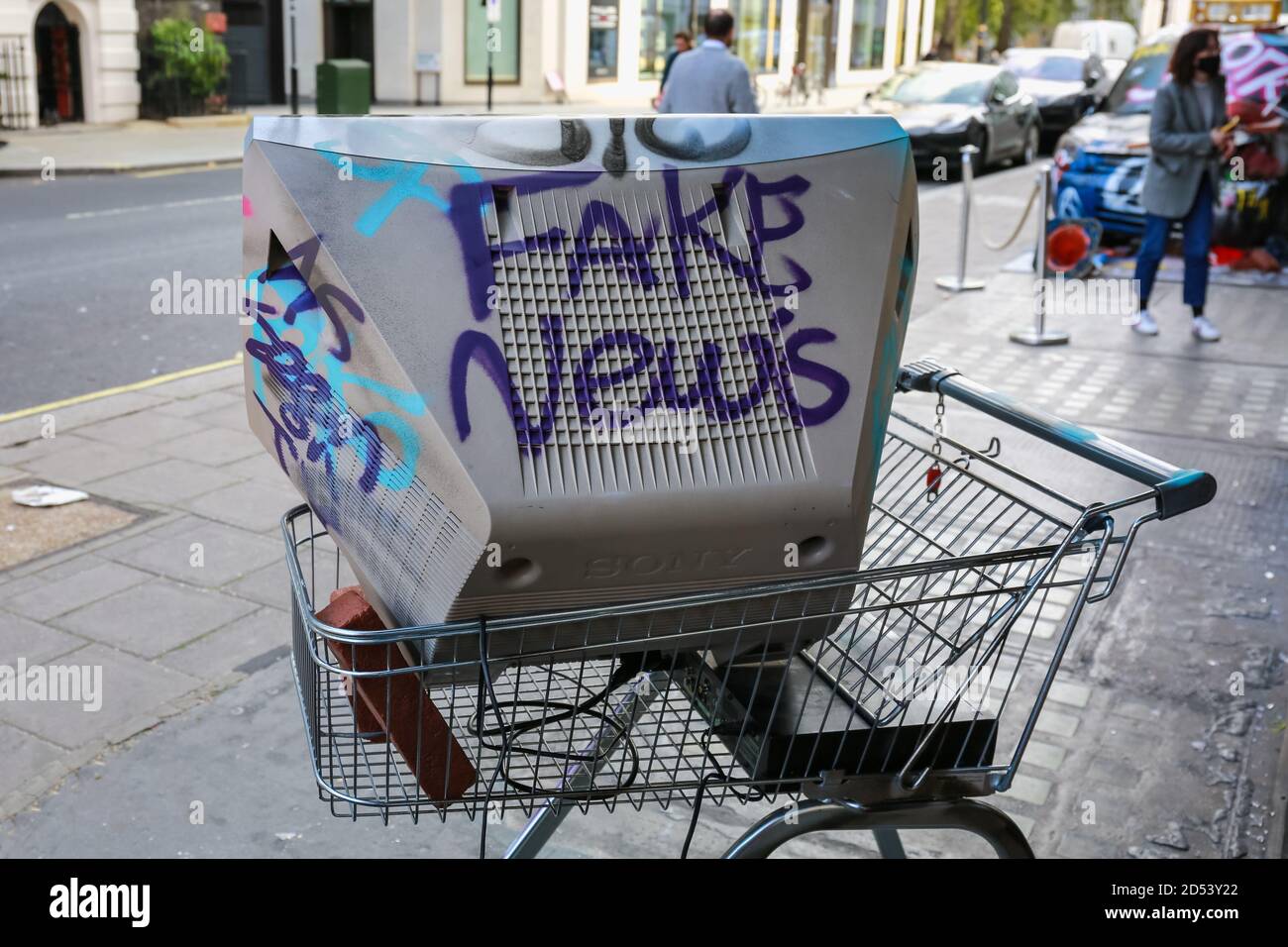 London, UK. 07 October 2020. A television on a shopping trolley with ...