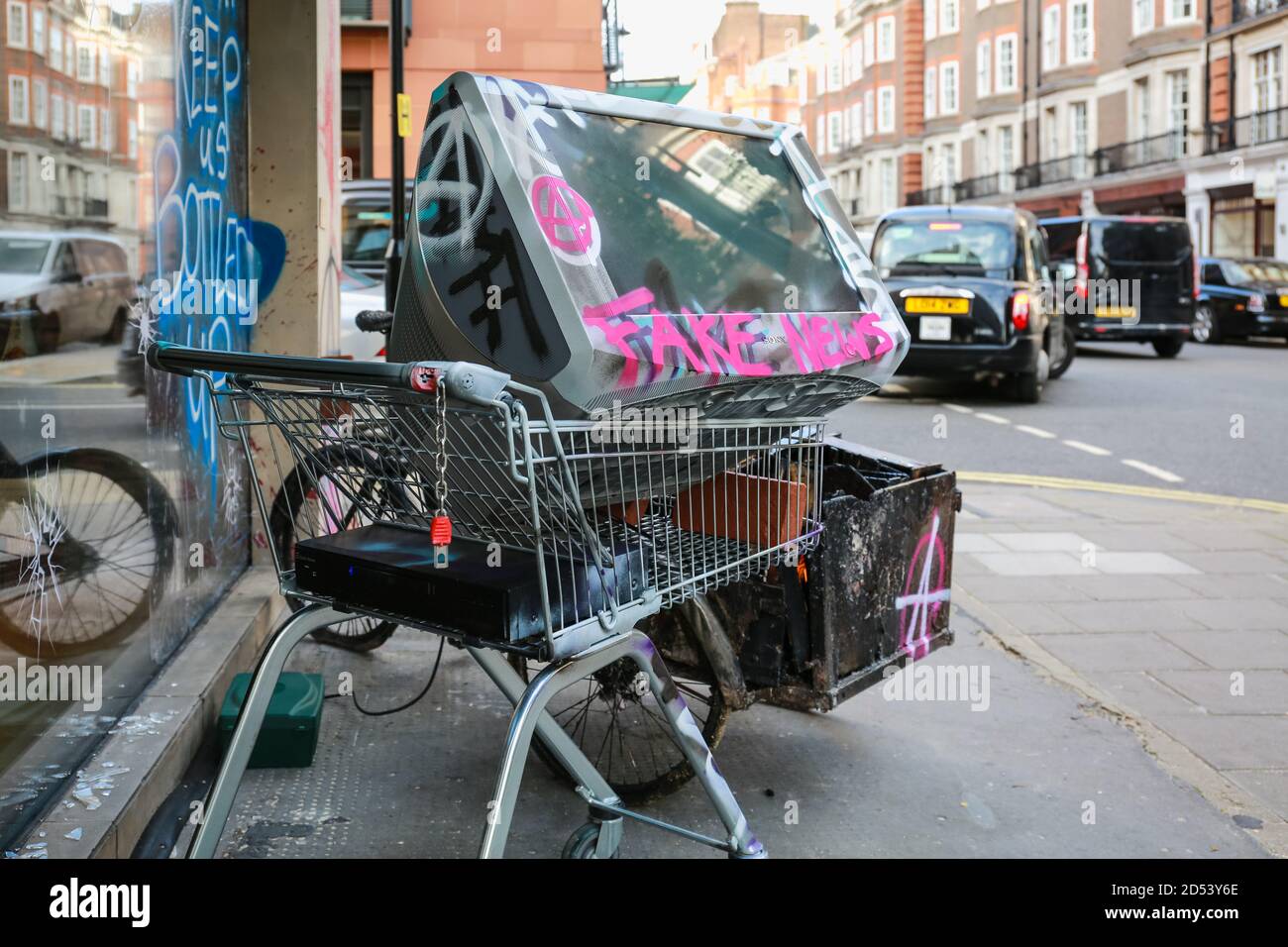 London, UK. 07 October 2020. A television on a shopping trolley with ...
