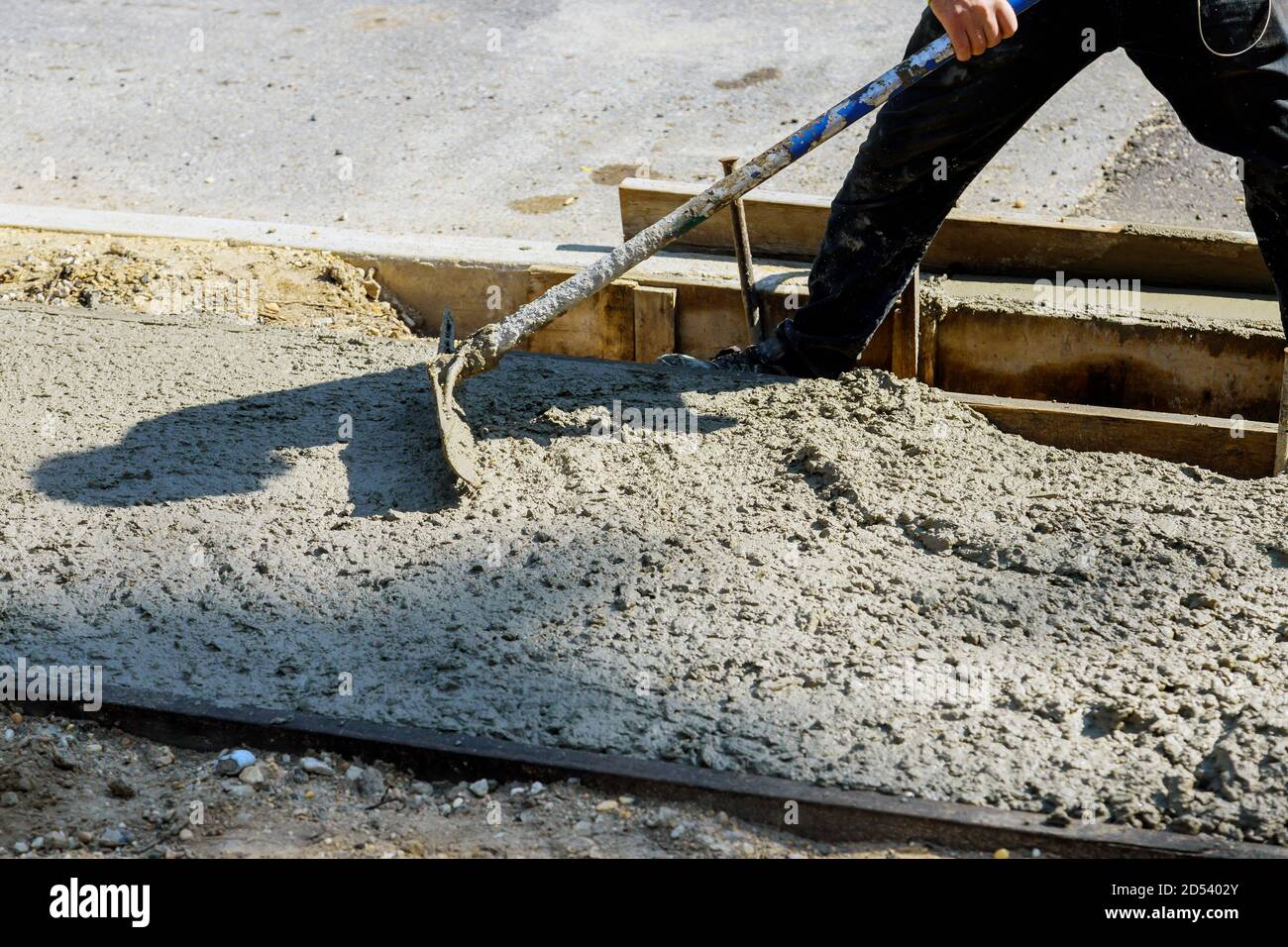 Cement in front of sidewalk a new building under construction worker ...