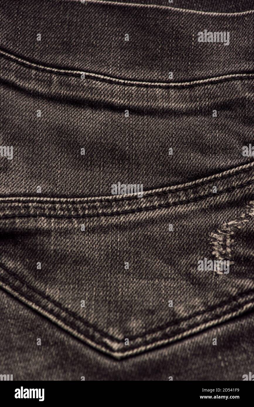 black Denim fabric texture. Black jeans denim cloth fragment as a ...