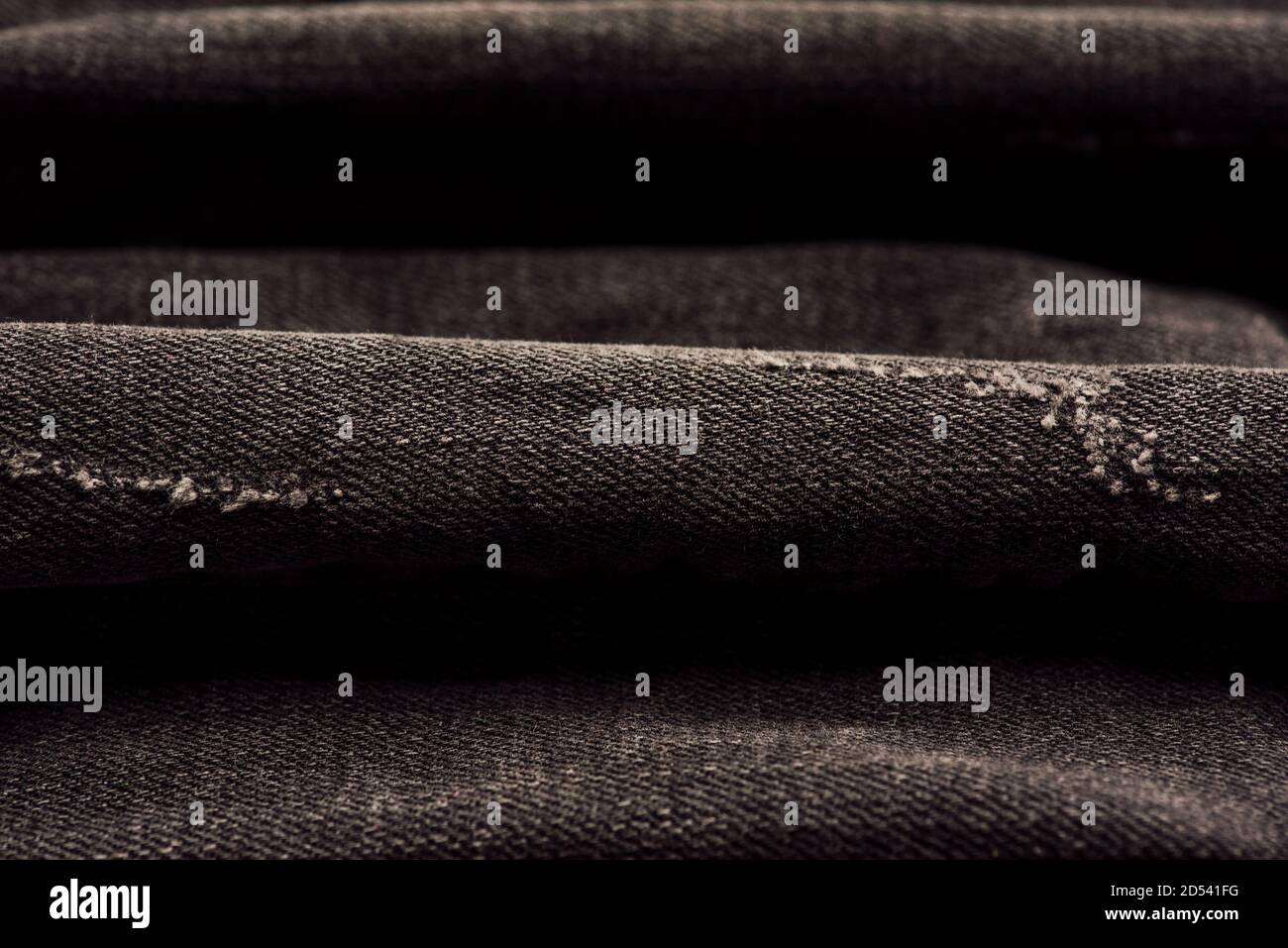 black Denim fabric texture. Black jeans denim cloth fragment as a ...