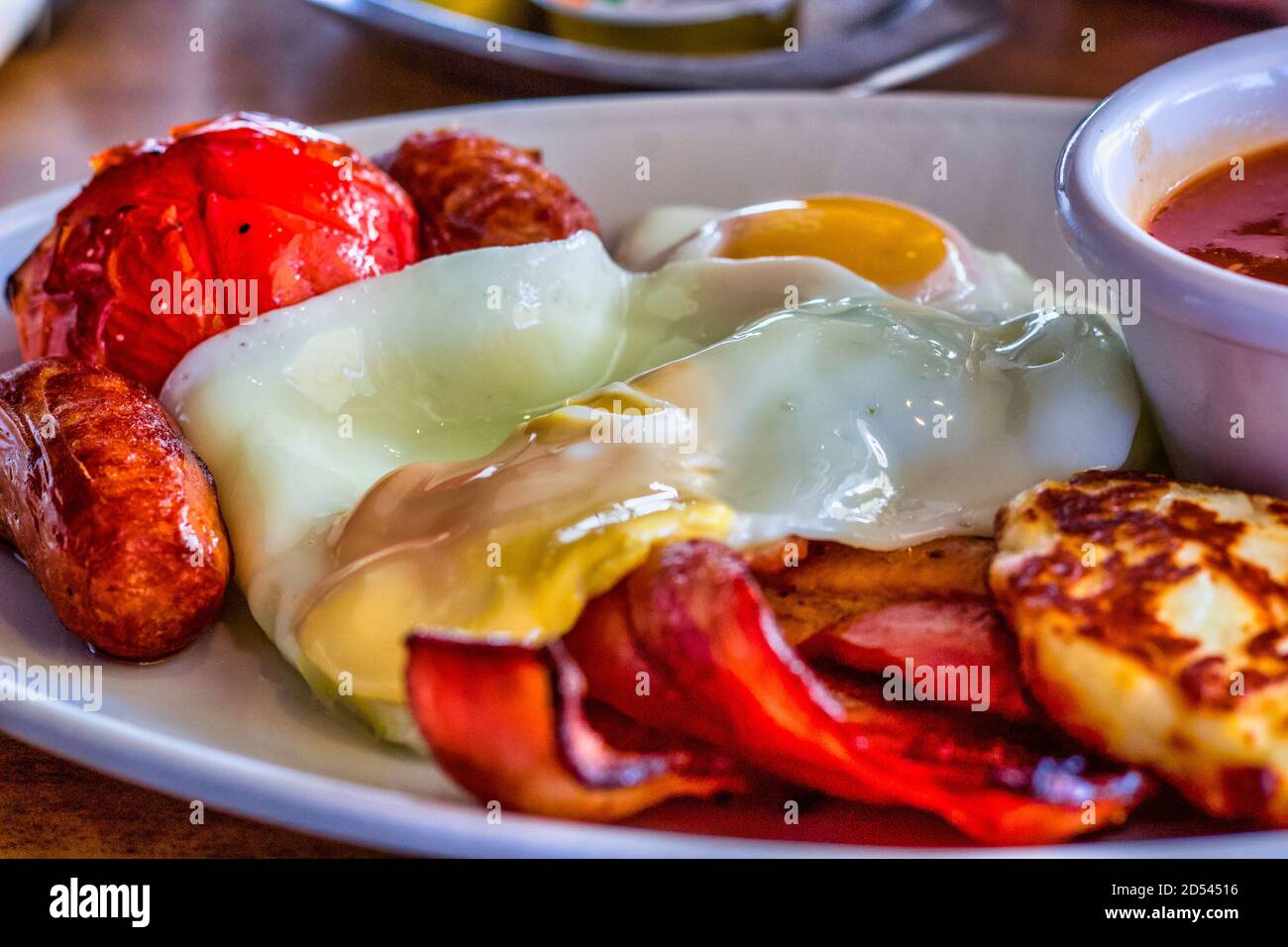 Closeup of a delicious full English breakfast on the table with a ...