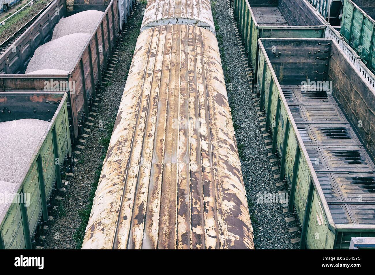 Rusty roof of a train next to freight cars on a railway Stock Photo - Alamy