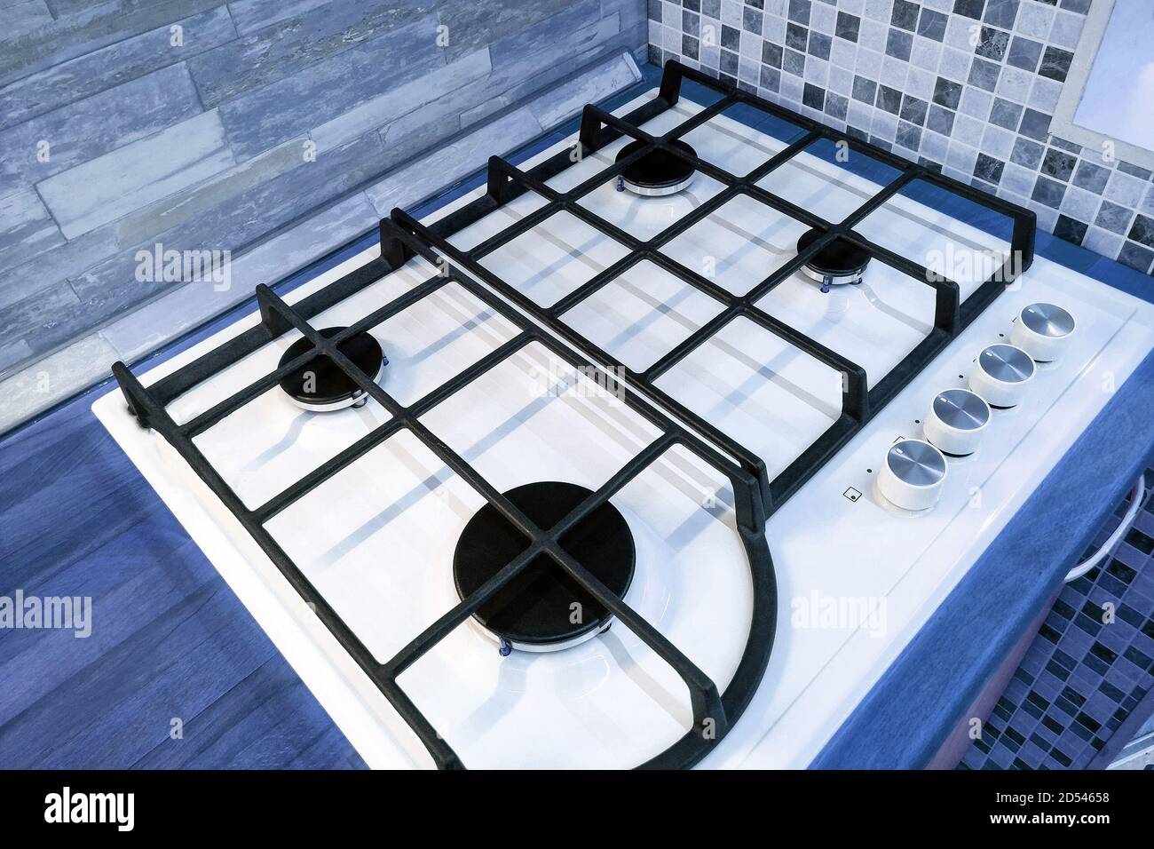 Gas stove in modern blue kitchen Stock Photo - Alamy