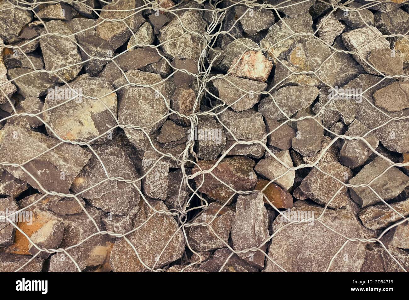 The texture of the walls of large rocks with metal protection from ...