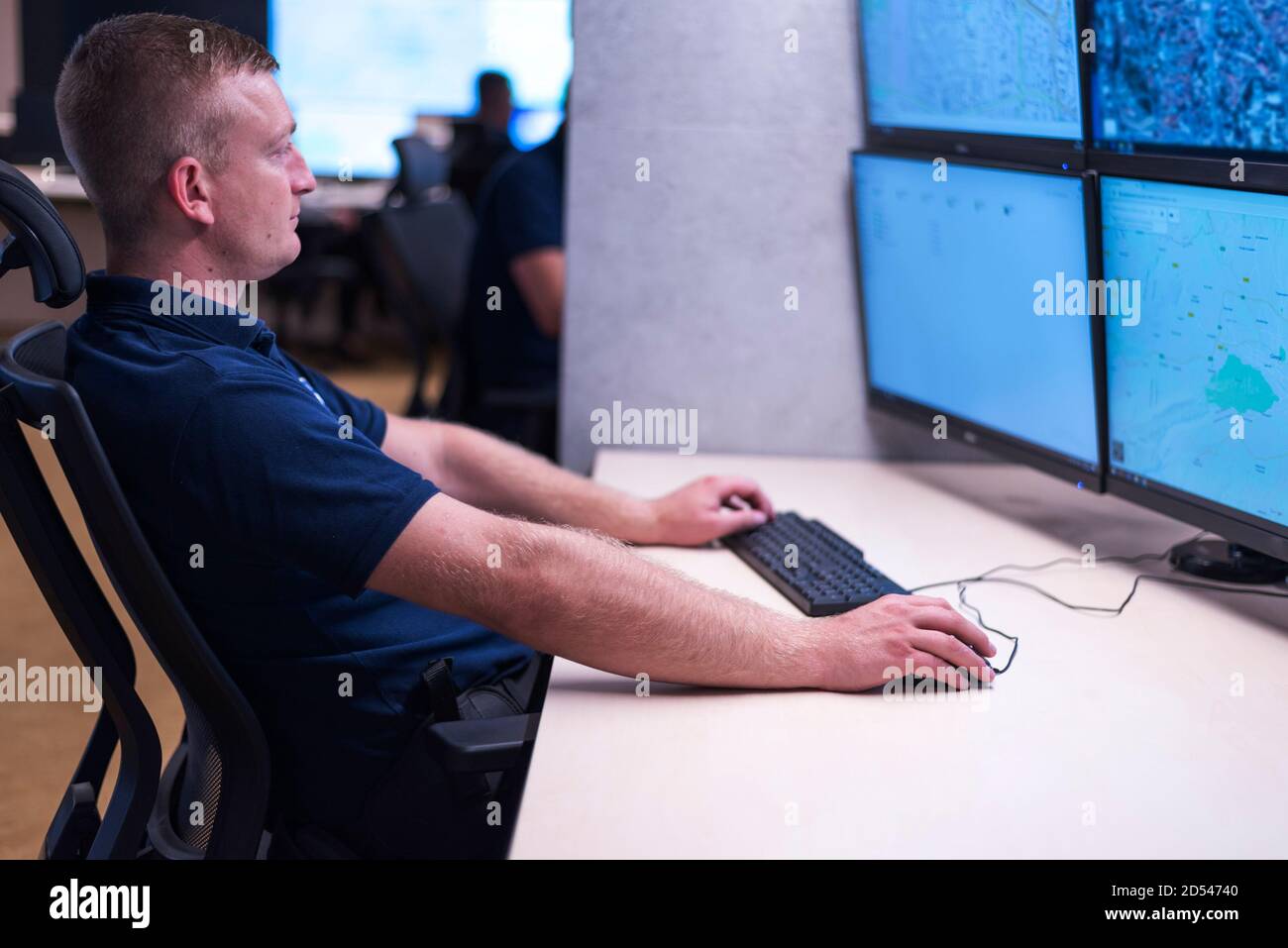 Male computer operator monitoring from a security ( computer, logistic ...