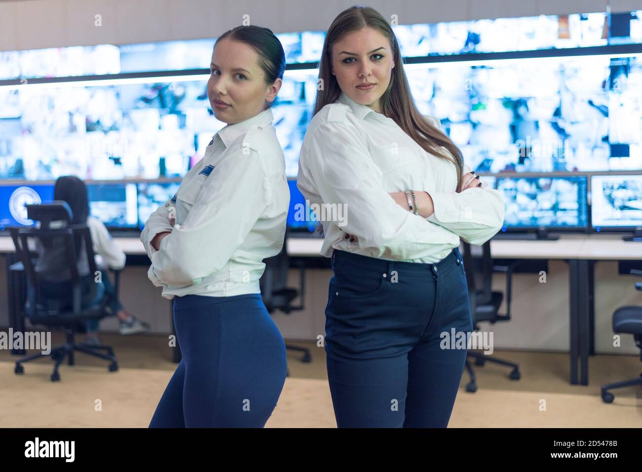 Security guard monitoring modern CCTV cameras in surveillance room. Two ...