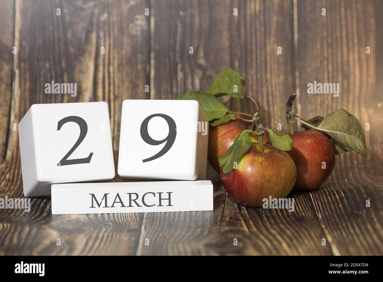 March 29. Day 29 of month. Calendar cube on wooden background with red ...
