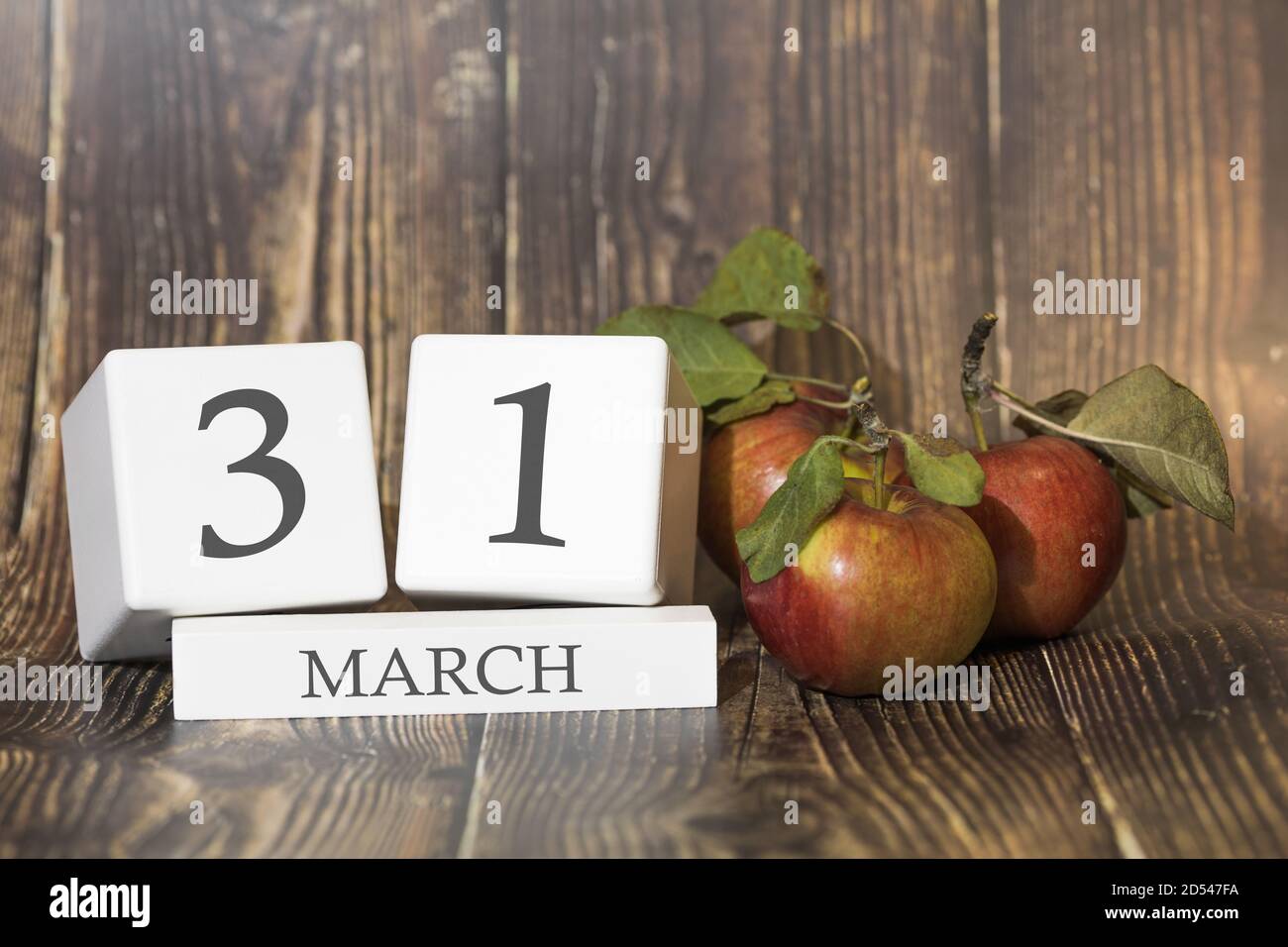 March 31. Day 31 of month. Calendar cube on wooden background with red ...