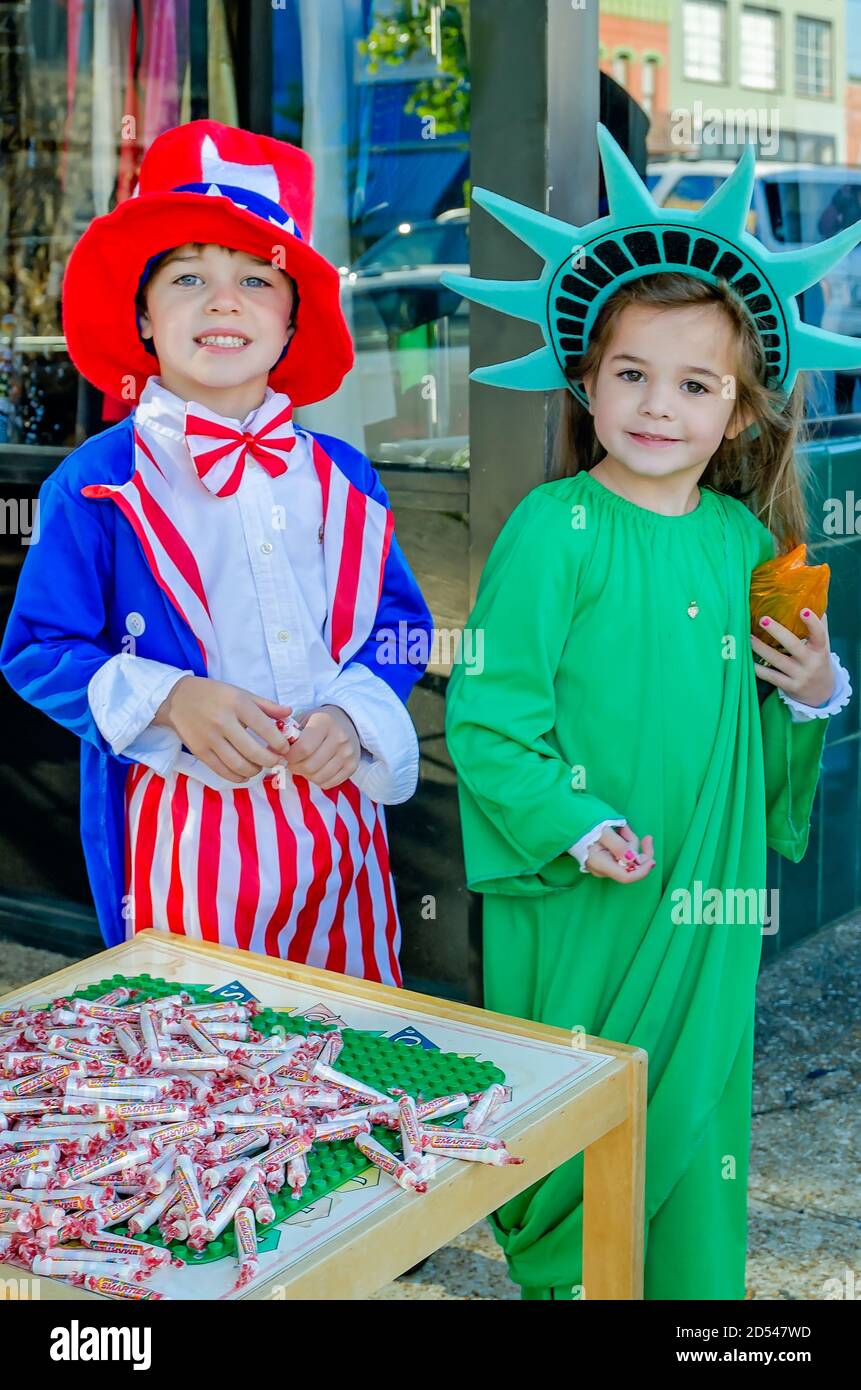 Children dressed as Uncle Sam and the Statue of Liberty give candy to ...