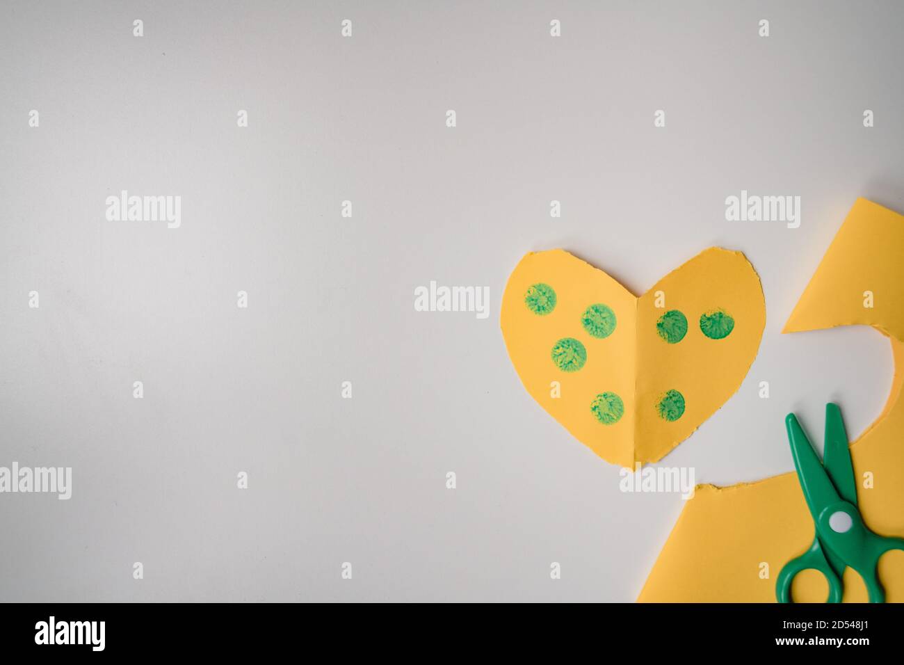 yellow paper heart craft activity Stock Photo - Alamy