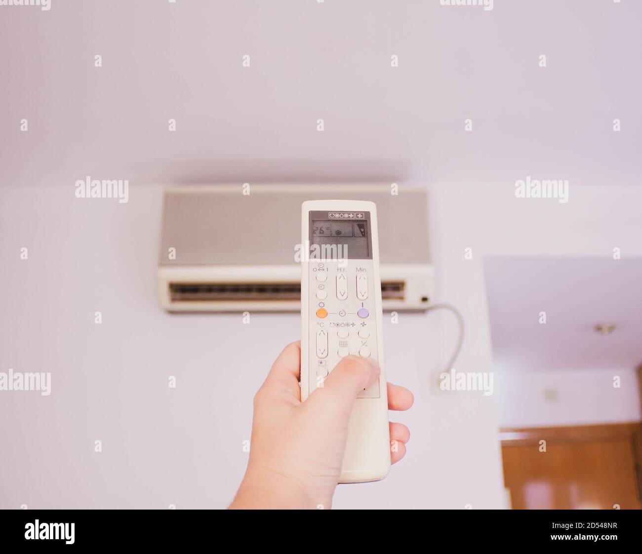 hand using the air conditioning control at home Stock Photo - Alamy