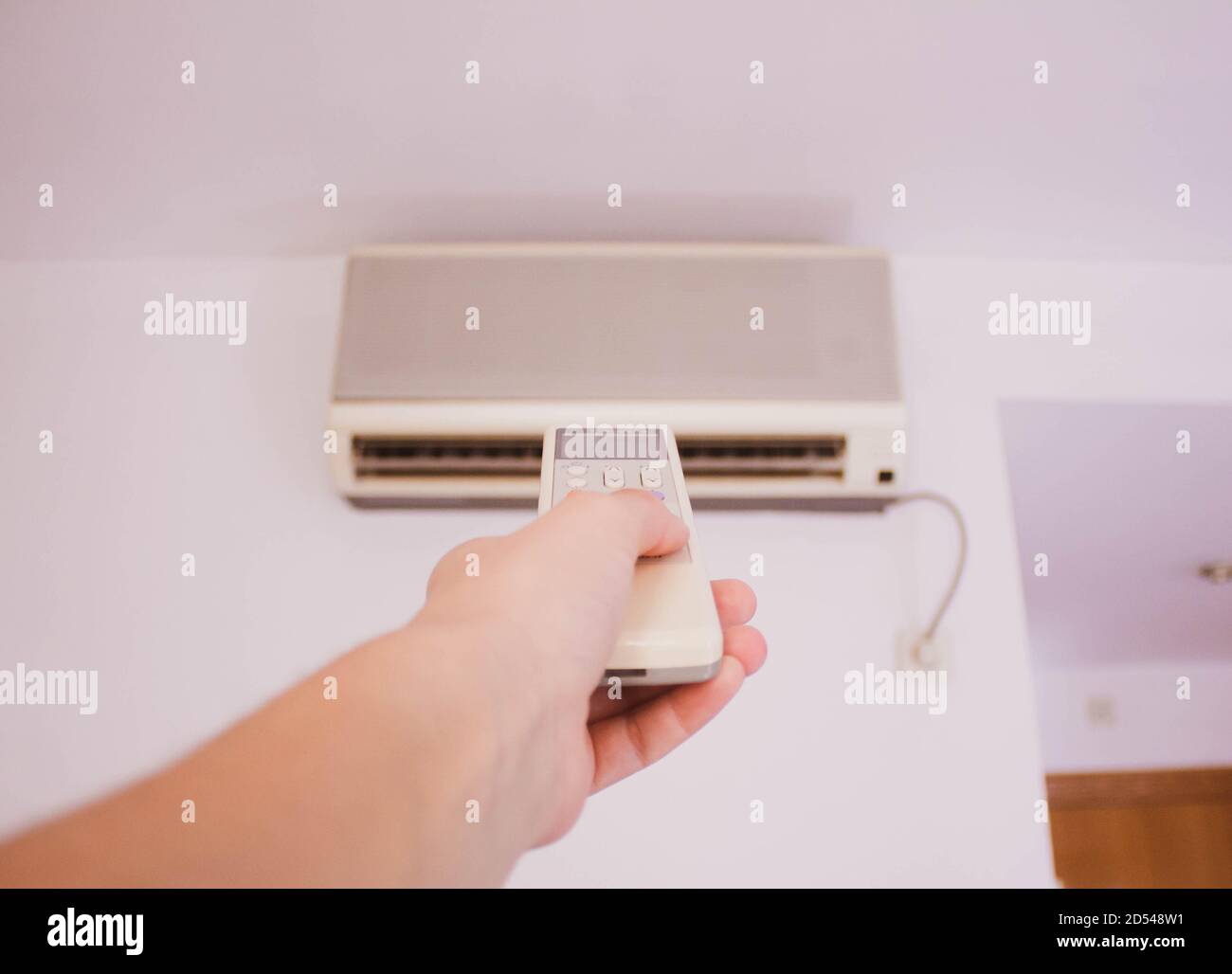hand using the air conditioning control at home Stock Photo - Alamy