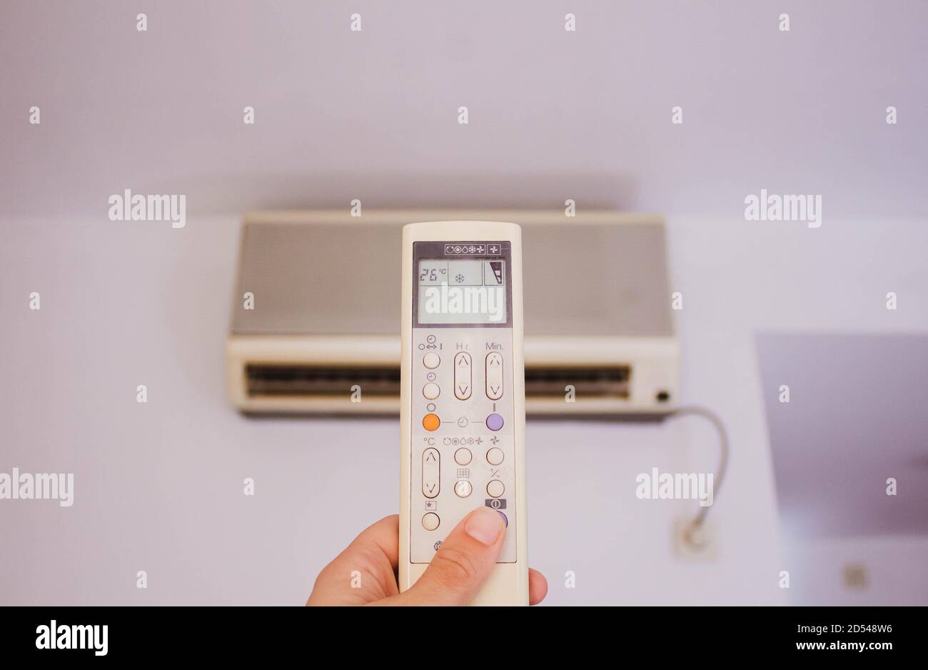 hand using the air conditioning control at home Stock Photo - Alamy