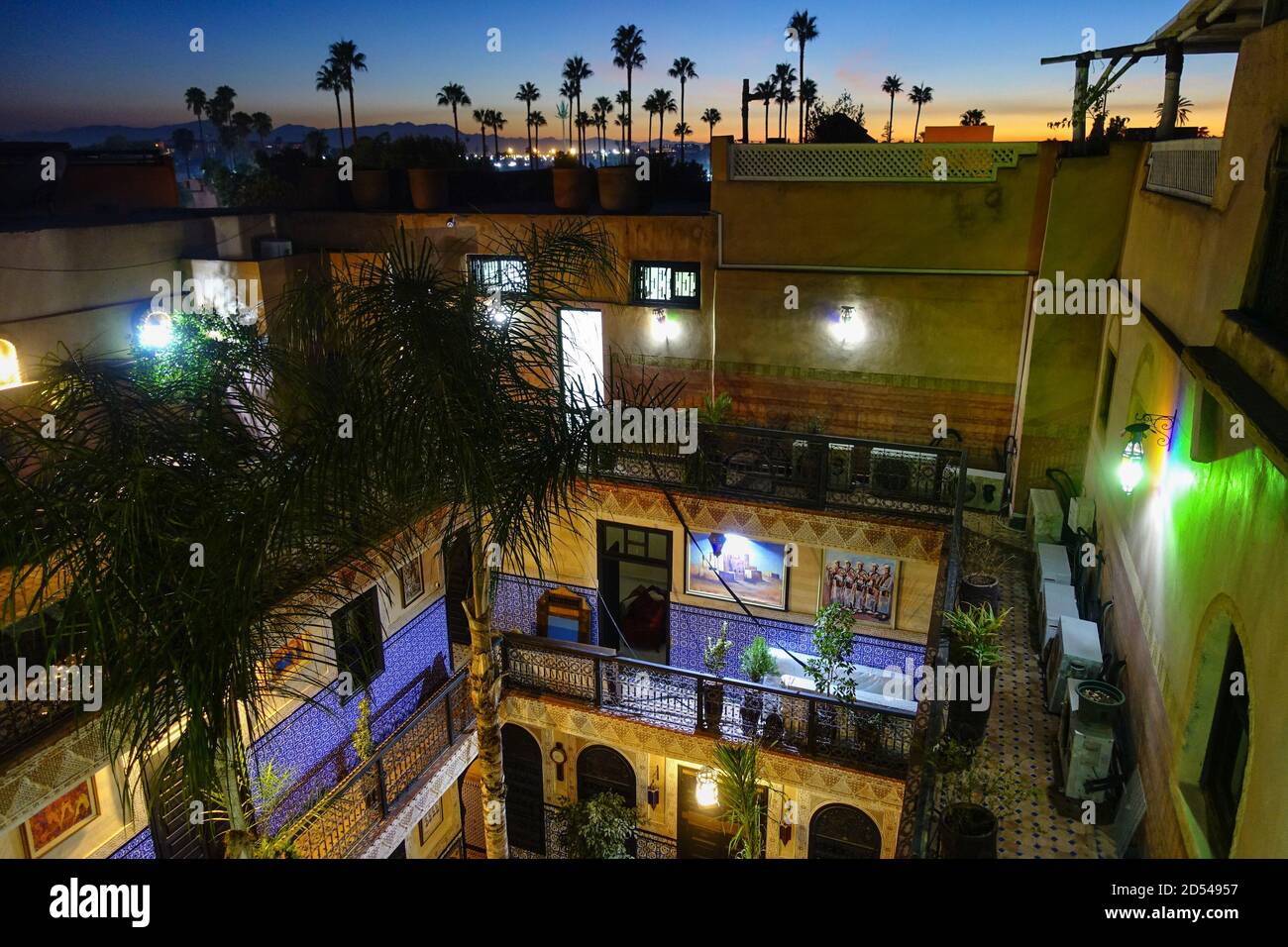 Beautiful Moroccan riad during sunset with palm trees in the background ...