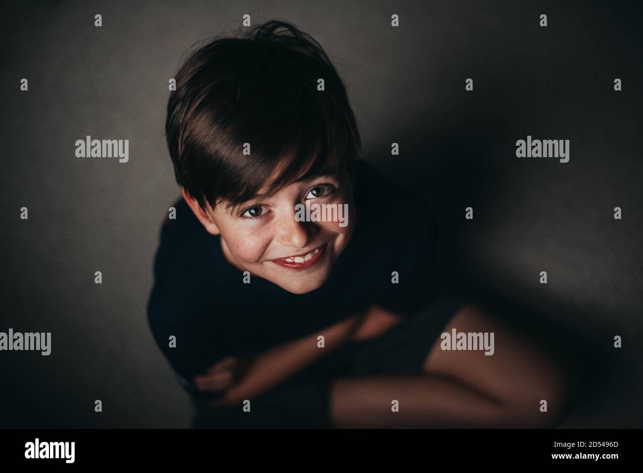 Portrait of young smiling boy with freckles shot from above Stock Photo ...