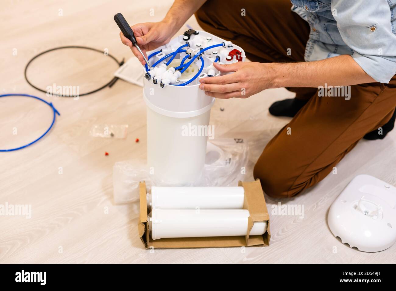 Plumber installs a water filter. water filter Stock Photo - Alamy