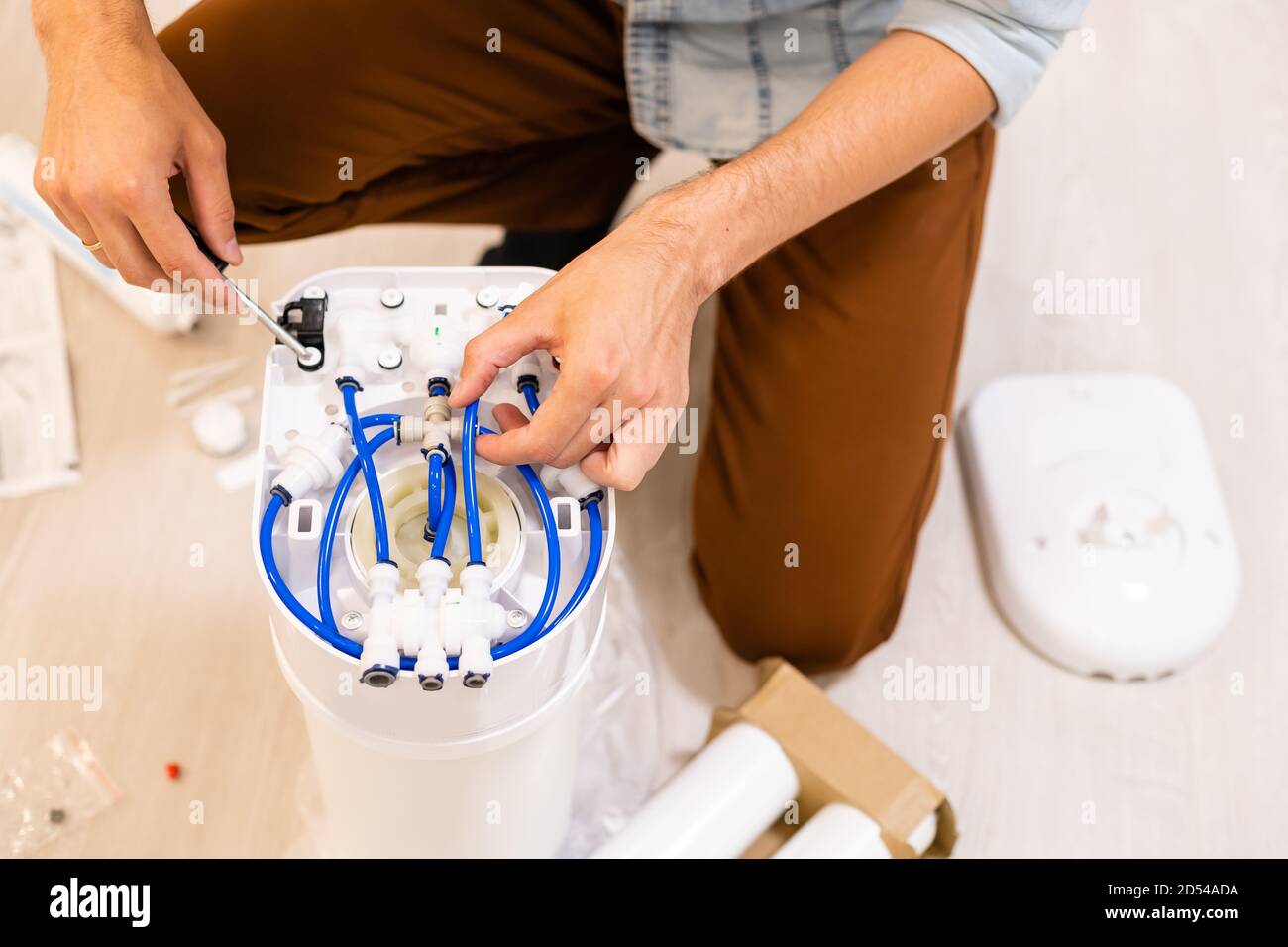 Plumber installs a water filter. water filter Stock Photo - Alamy