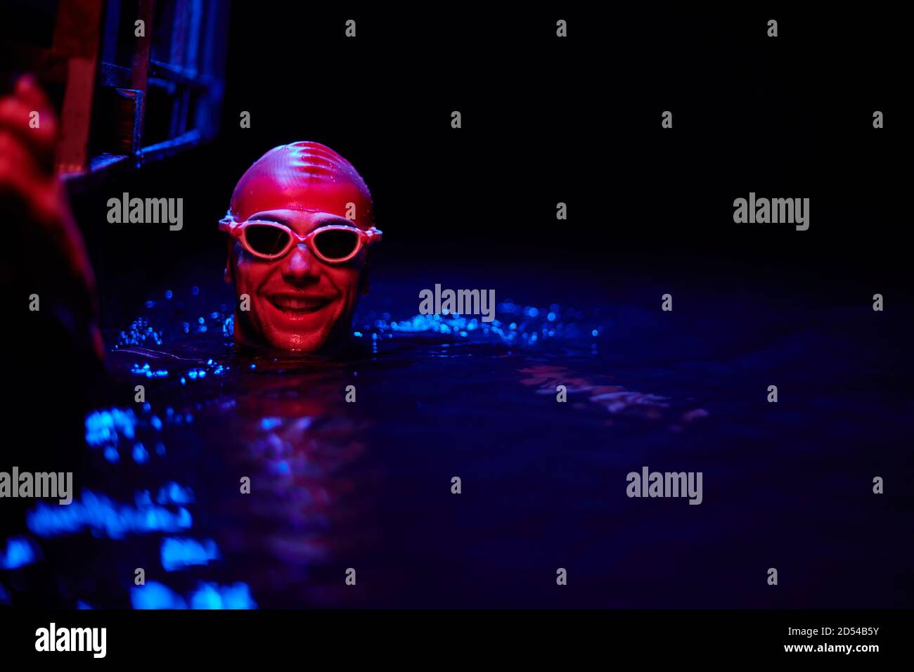 authentic triathlete swimmer having a break during hard training on ...