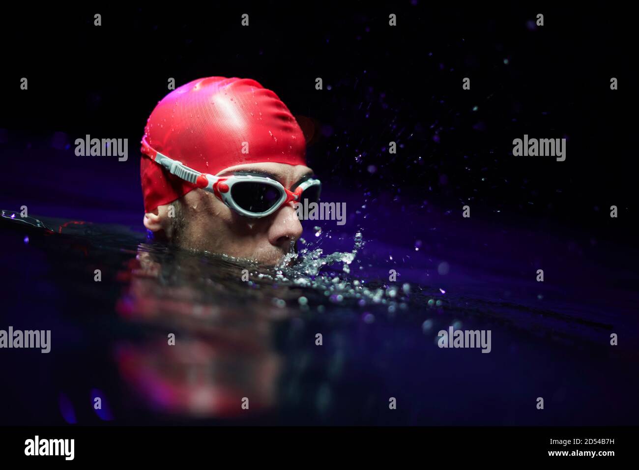authentic triathlete swimmer having a break during hard training on ...