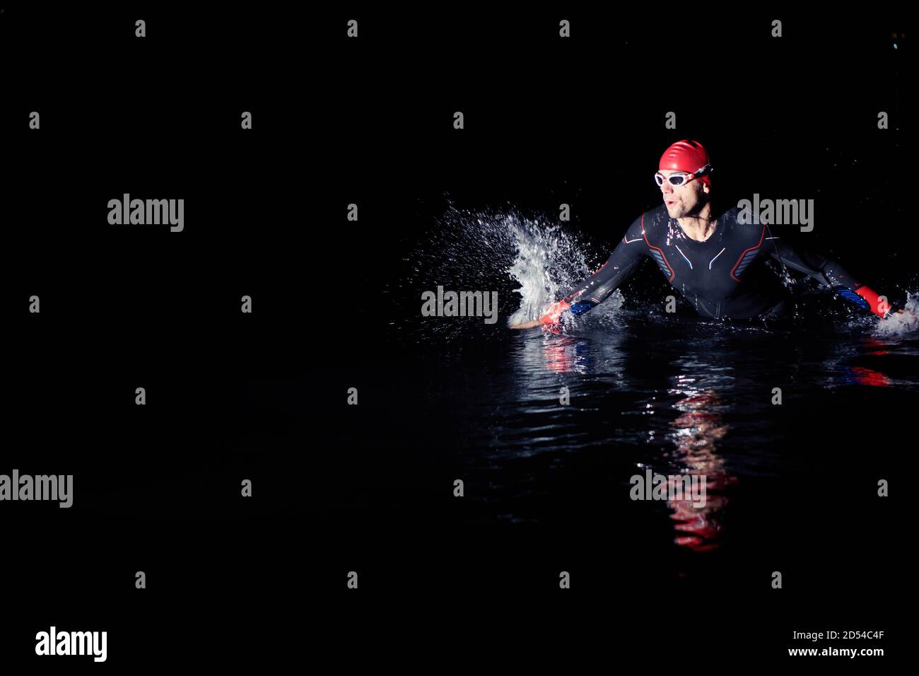 triathlon athlete finishing swimming training at dark night Stock Photo ...