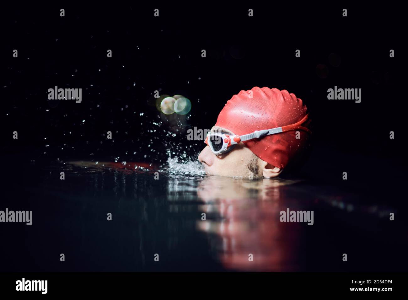 authentic triathlete swimmer having a break during hard training on ...