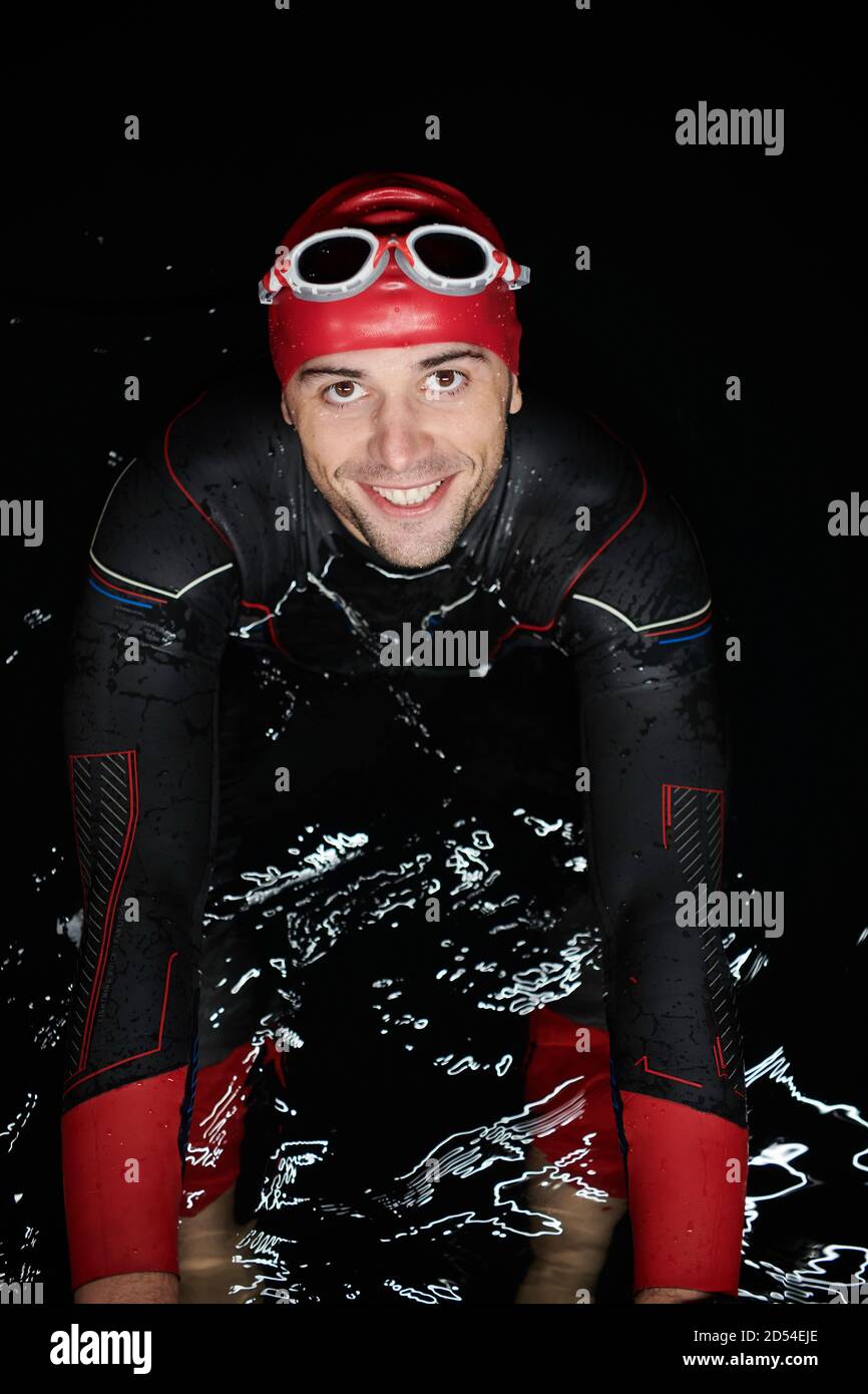 authentic triathlete swimmer having a break during hard training on ...