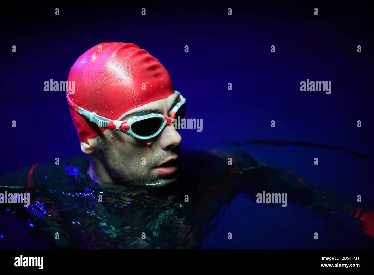 authentic triathlete swimmer having a break during hard training on ...