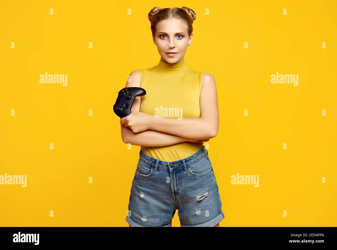 Portrait of gorgeous happy blonde gamer girl playing video games using ...