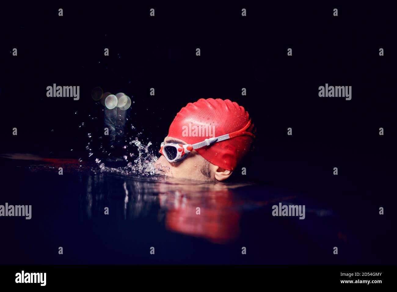 authentic triathlete swimmer having a break during hard training on ...