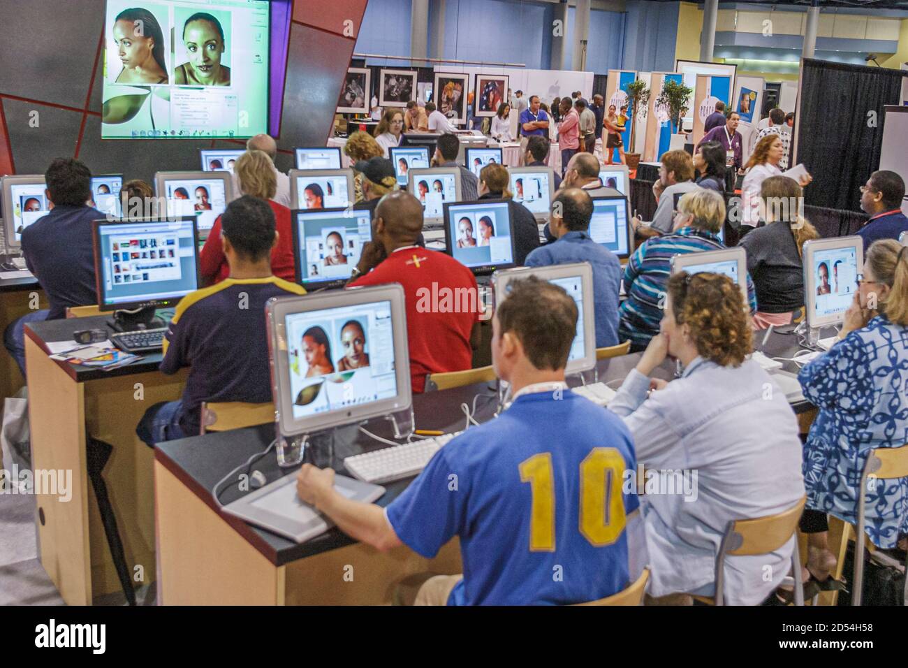 Adobe technology seminar man woman female computer station screen ...