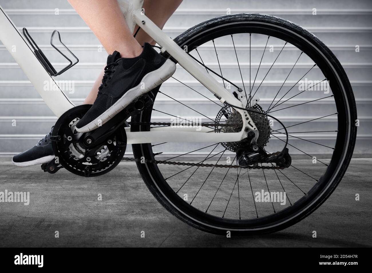 Side view of a woman riding a bicycle on the street Stock Photo - Alamy