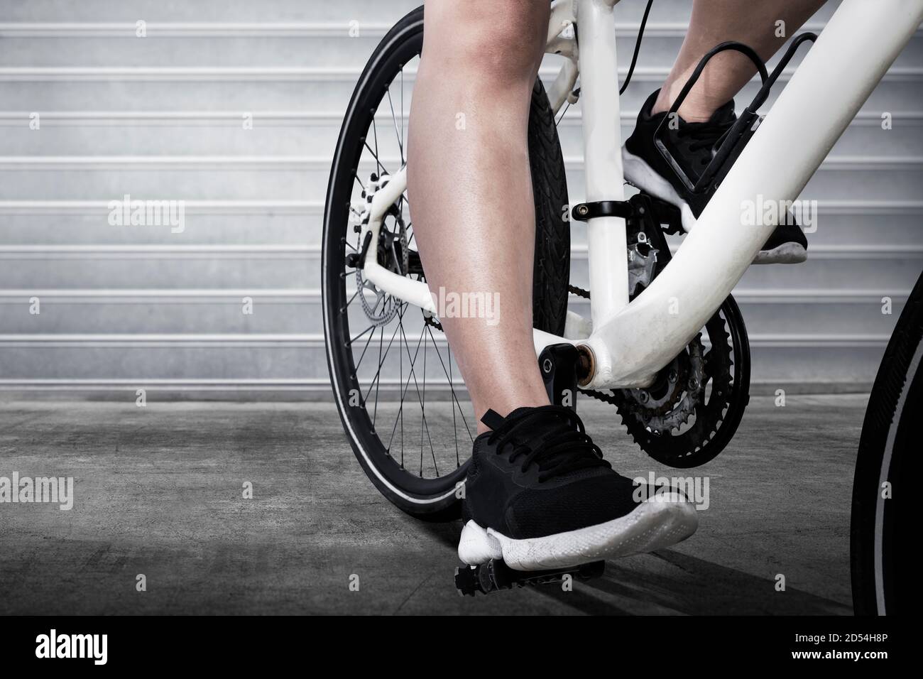 Side view of a woman riding a bicycle on the street Stock Photo - Alamy