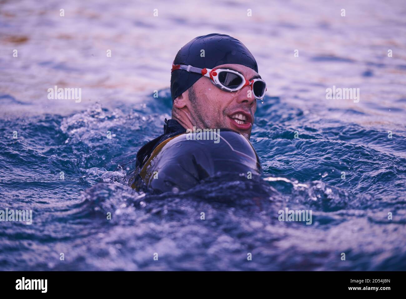 triathlete swimmer having a break during hard training Stock Photo - Alamy