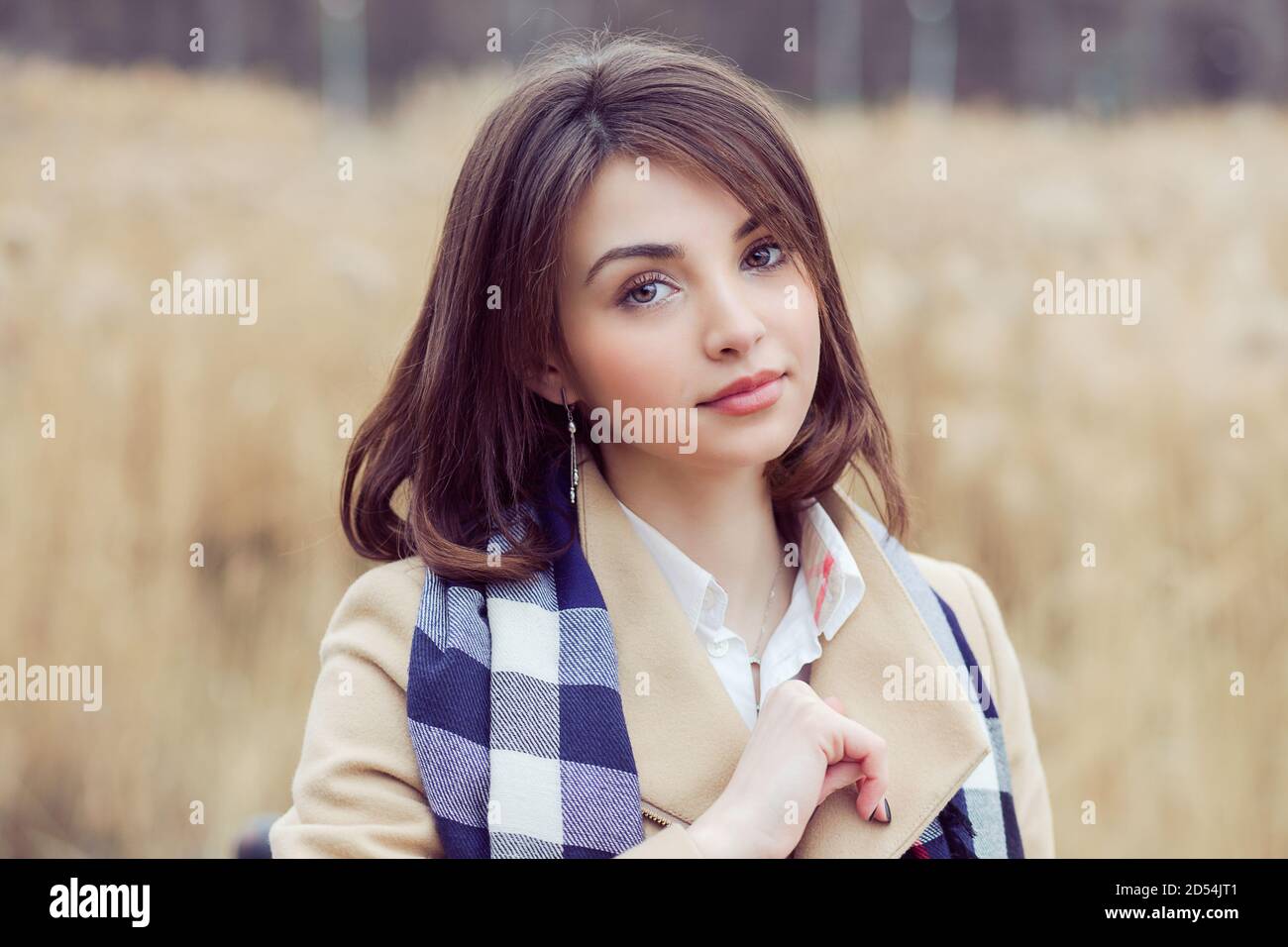 Happy and cheerful. Portrait of a woman smile no teeth outdoors autumn ...