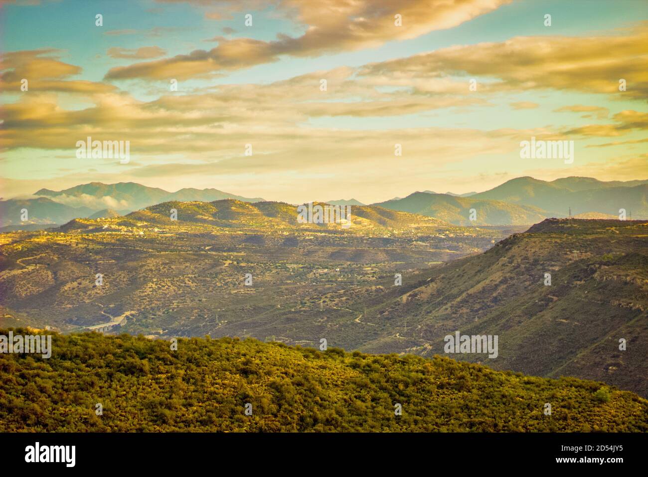 Landscape of mountains covered in greenery during a beautiful sunset in ...